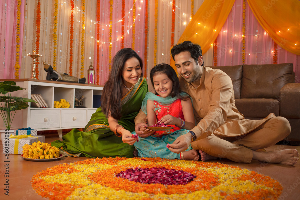 Young Indian/asian family making flower rangoli for Diwali festival ...