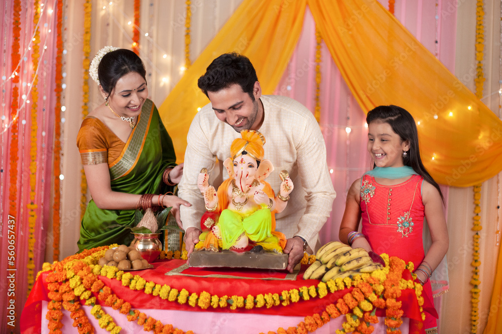 Cheerful Indian family welcoming Lord Ganesha idol on Ganesh festival ...