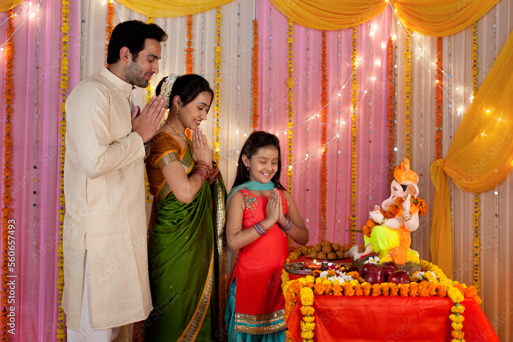 Portrait of an Indian family doing puja / pooja at Ganesh Chaturthi ...