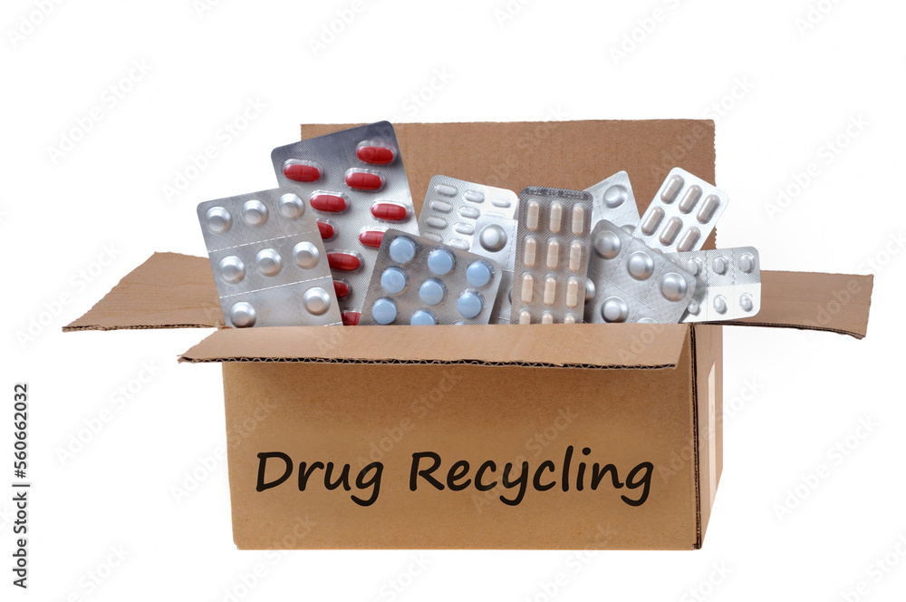 Blister packs of drugs for recycling in an open cardboard box close-up ...