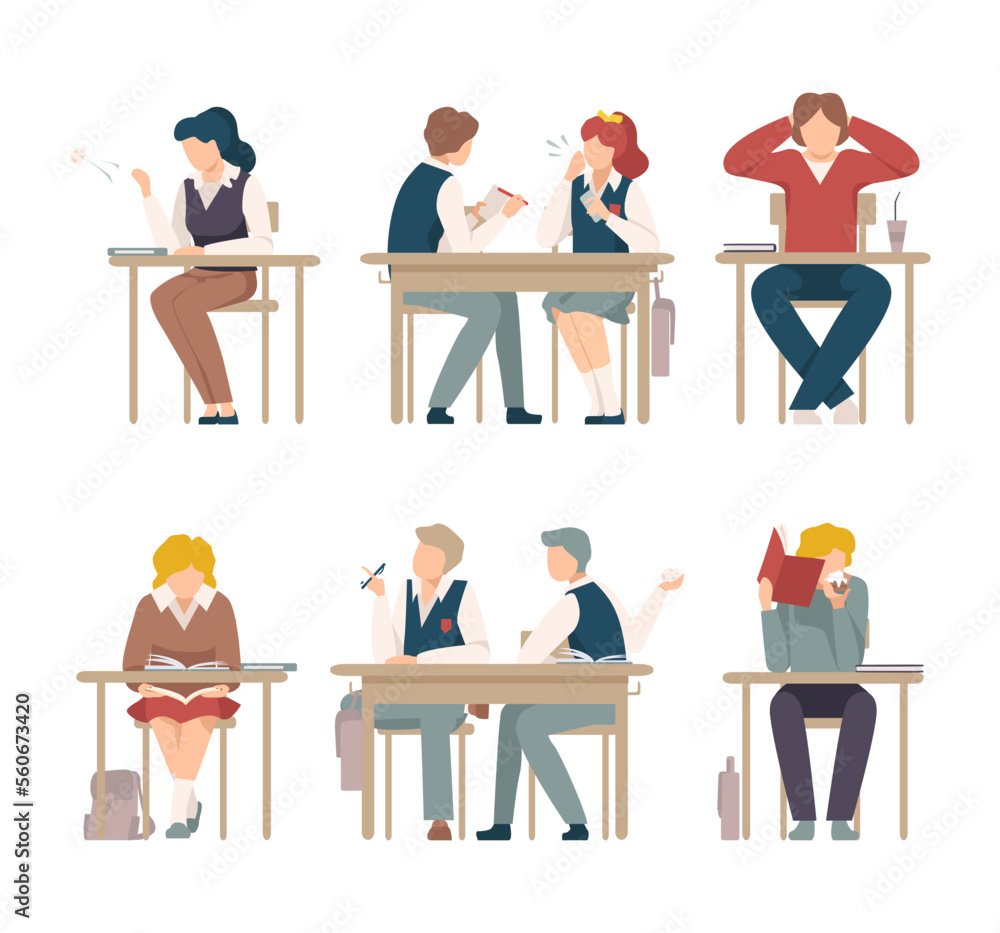 Teenage students sitting at desk in classroom. Girls and guys in ...