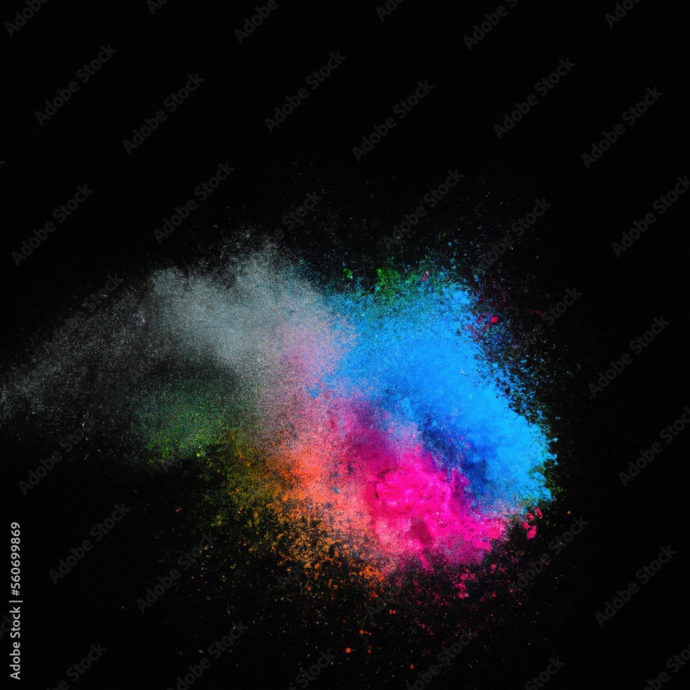 Explosion of colorful powder isolated on dark black background. Holi ...