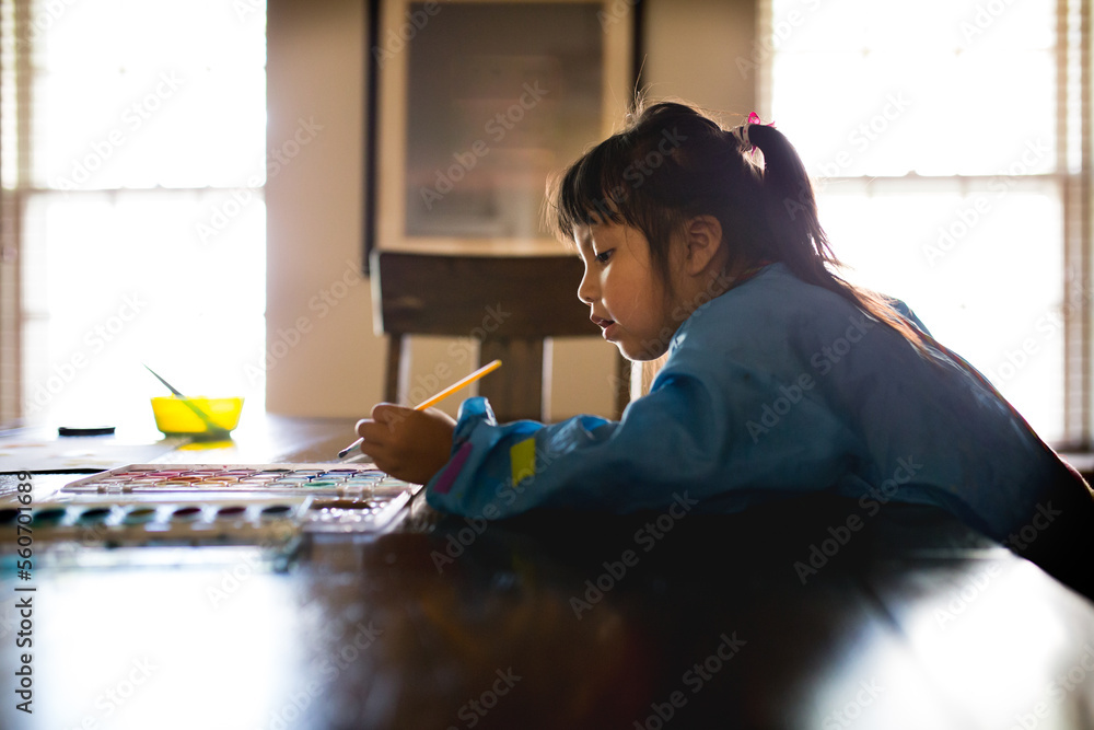Young girl painting a colorful watercolor picture Stock Photo | Adobe Stock