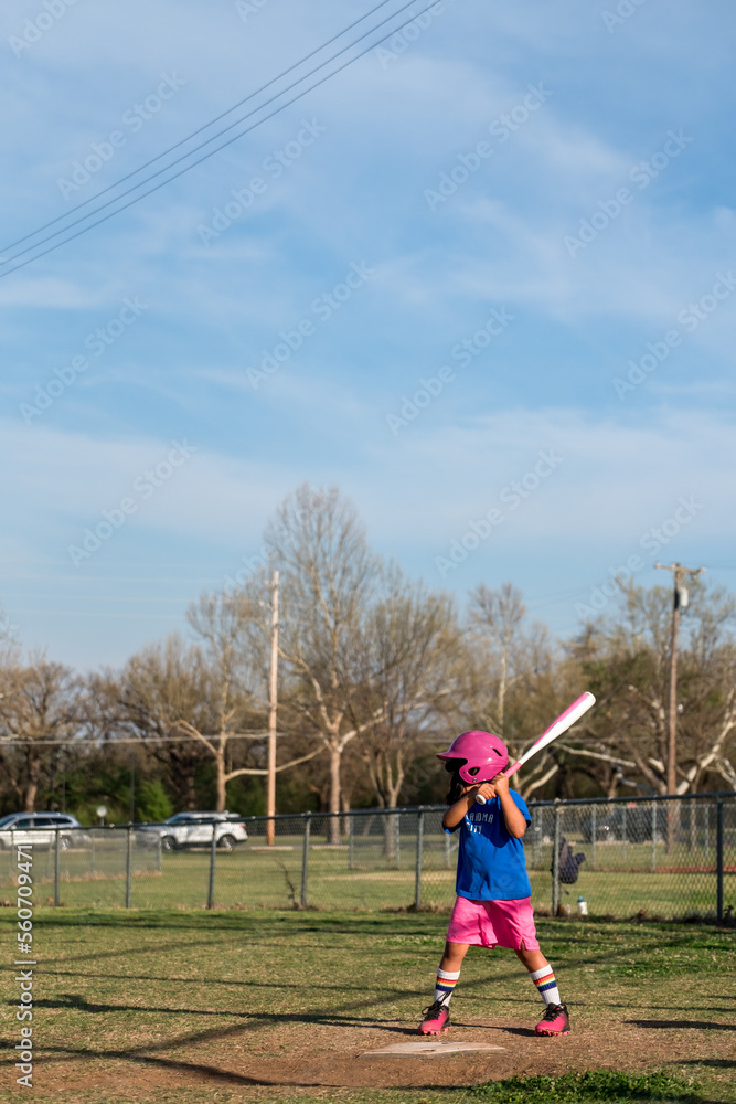 Girl playing baseball wearing colorful uniform 3 Stock Photo | Adobe Stock