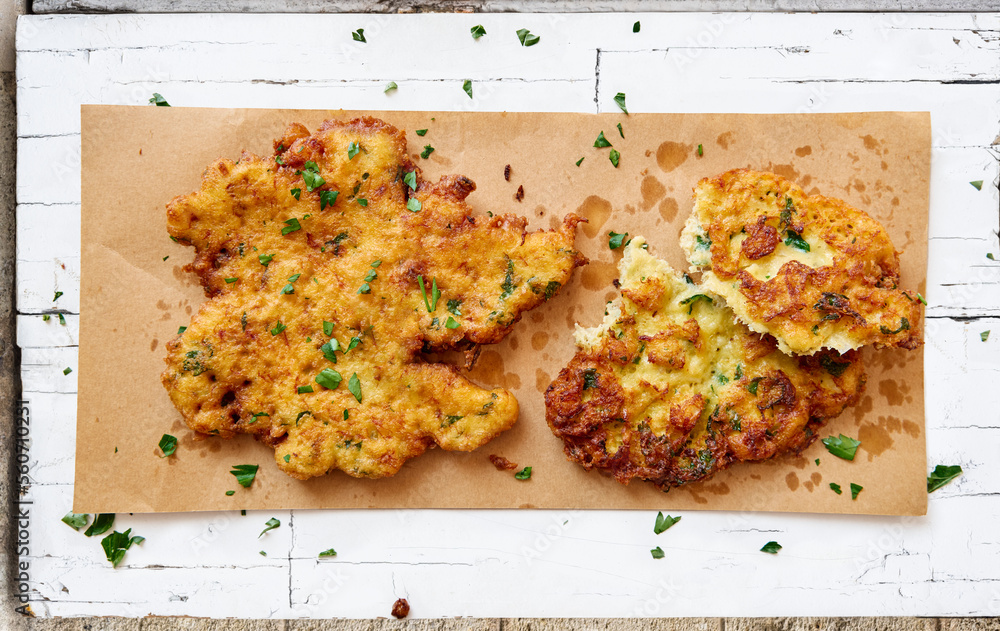 Pataniscas de bacalhau on a white rustic wooden board. Pataniscas are ...