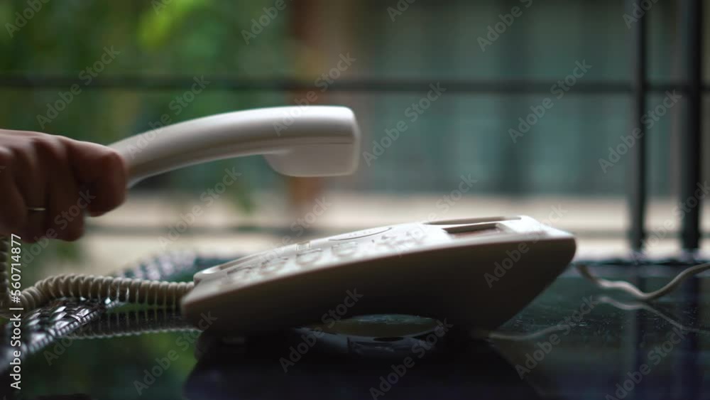 outside shot. Man hand office worker picking up the phone to answer a ...