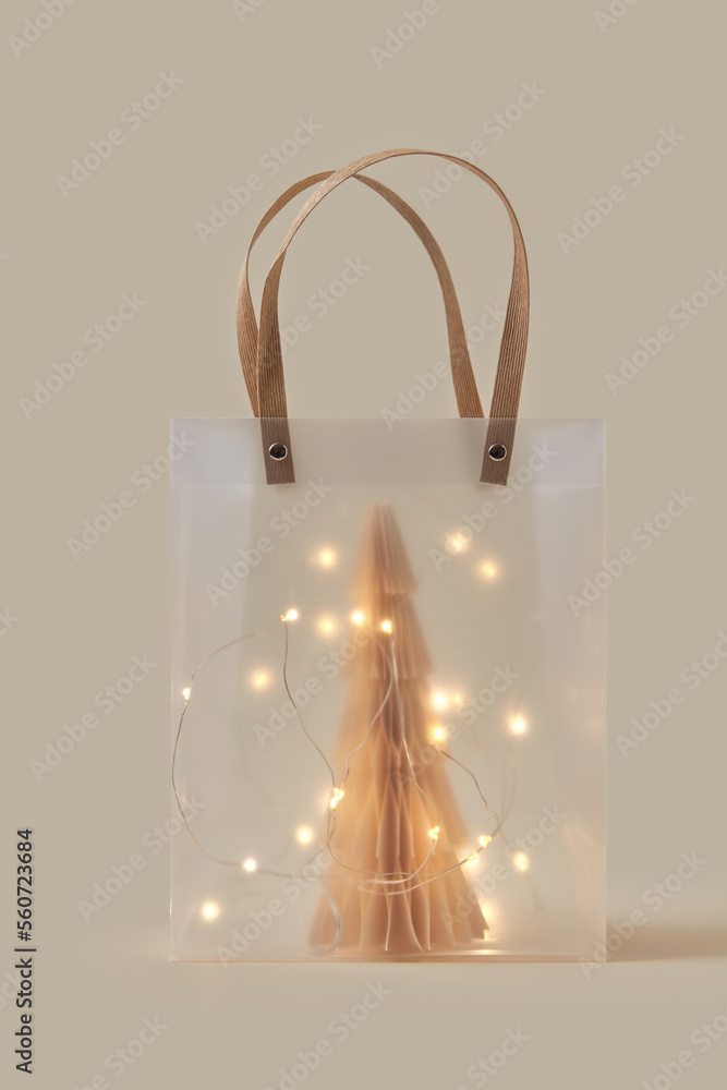 Plastic shopper with papercraft Christmas tree. Stock Photo | Adobe Stock