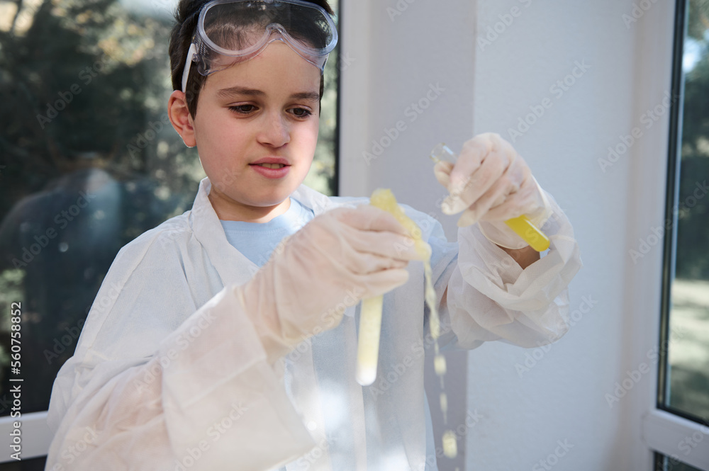 Inspired smart teenage schoolboy, a chemist scientist in safety lab ...