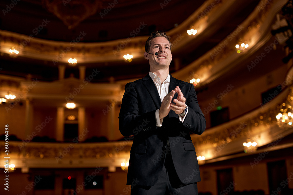 Confident guy of american appearance in formal classic suit clapping ...