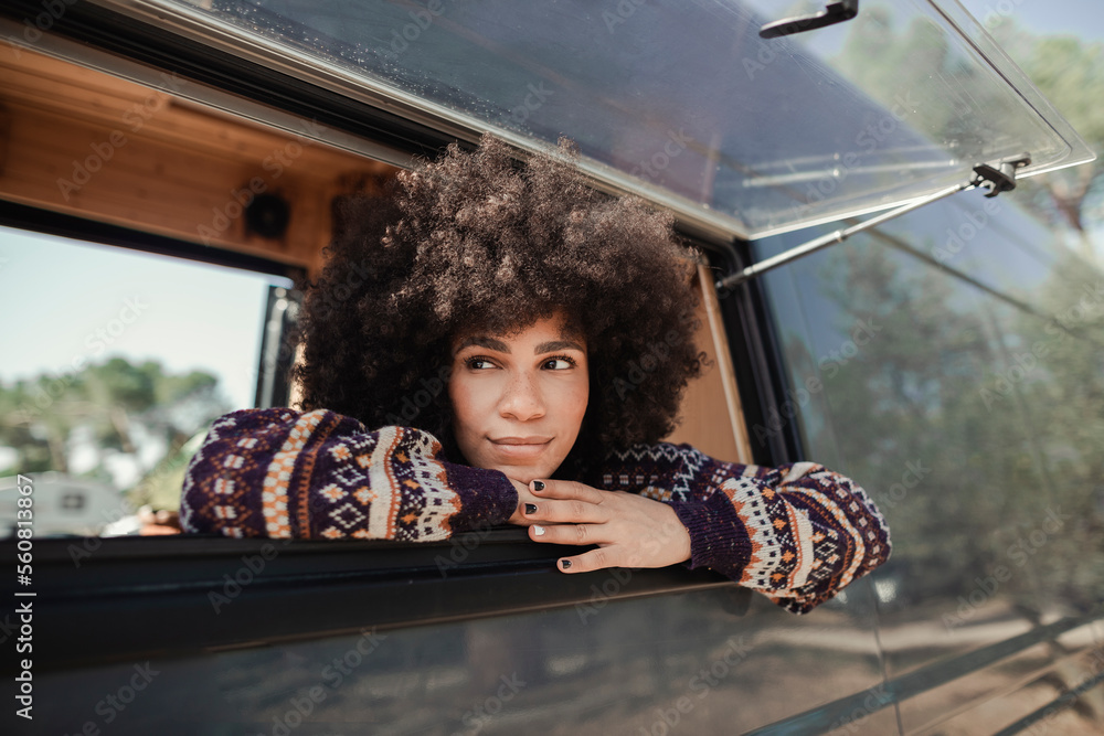 Girl leaning out of the window of her camper van Stock Photo | Adobe Stock