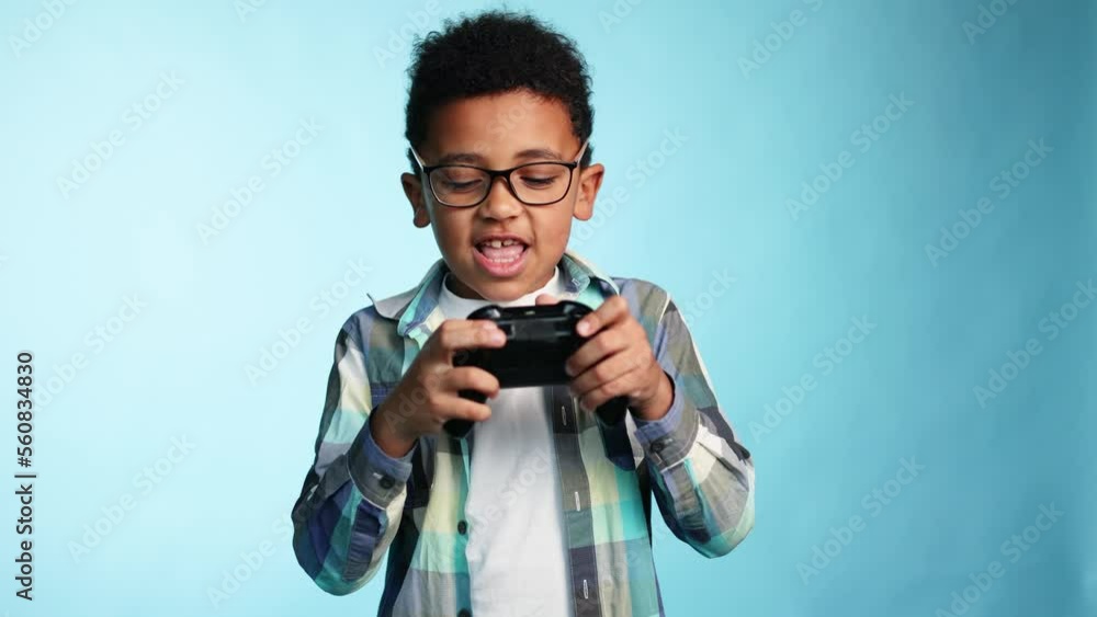 Excited cute little boy kid with joystick controller playing video ...