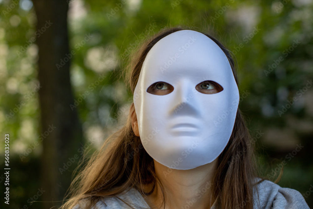 woman with full face white mask sitting in the woods Stock Photo ...
