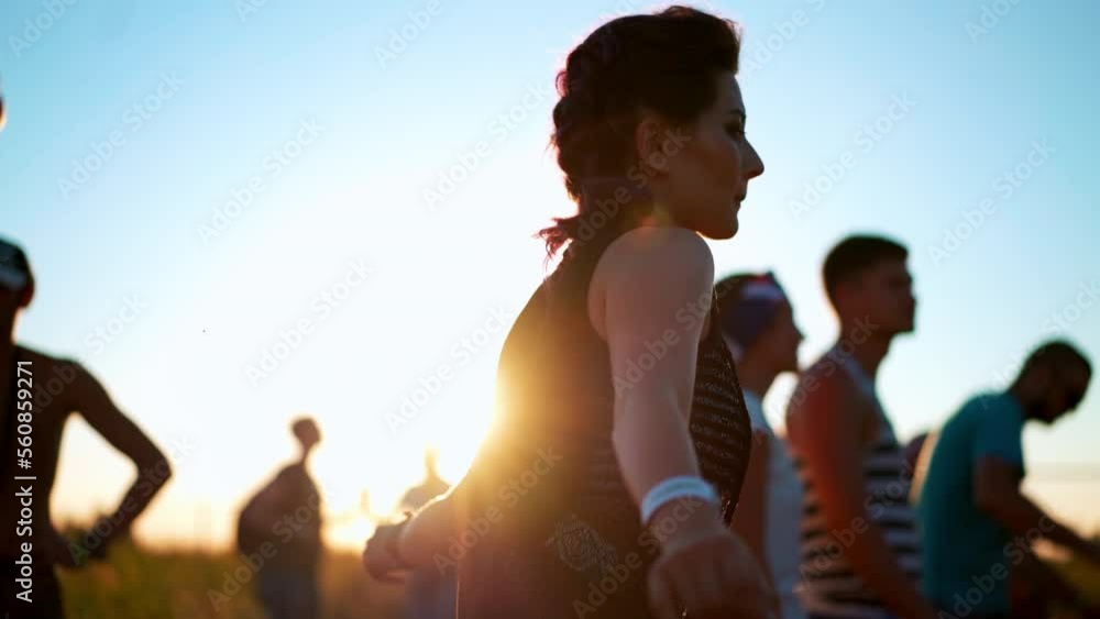 Woman dancing near stage. Diverse group of fans dancing at openair live ...