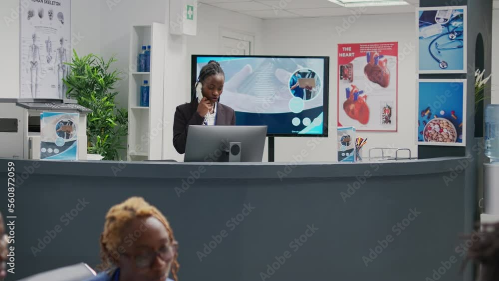 African american receptionist working at hospital reception counter ...