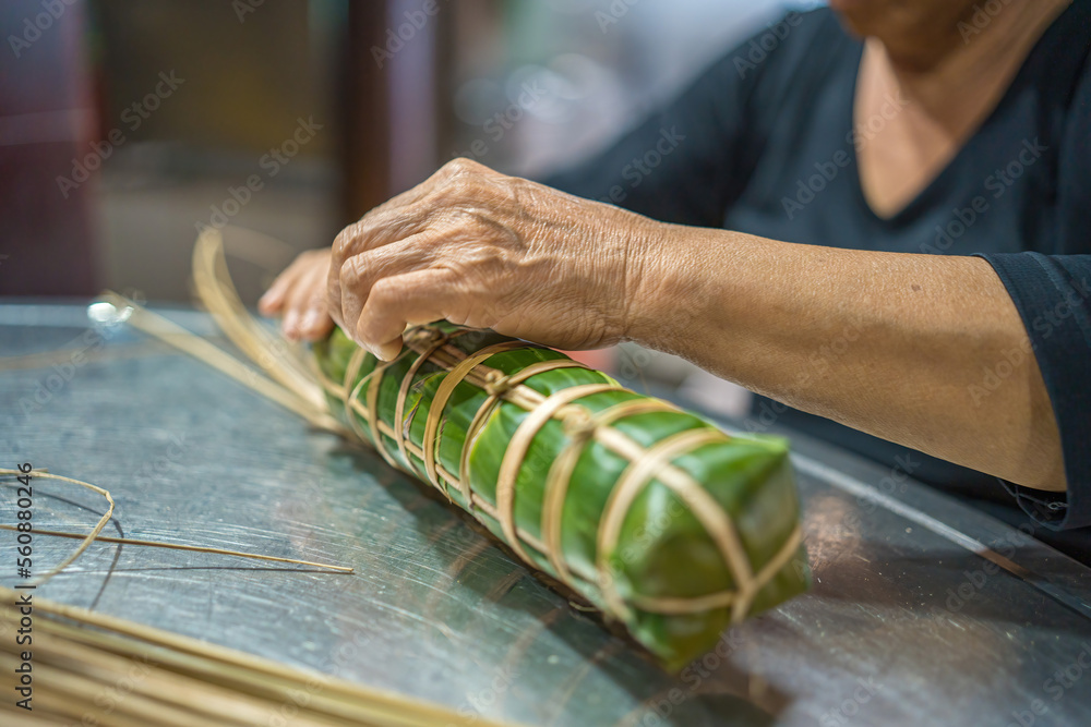 Focus old woman with traditional Vietnamese dress (ao ba ba) Making ...