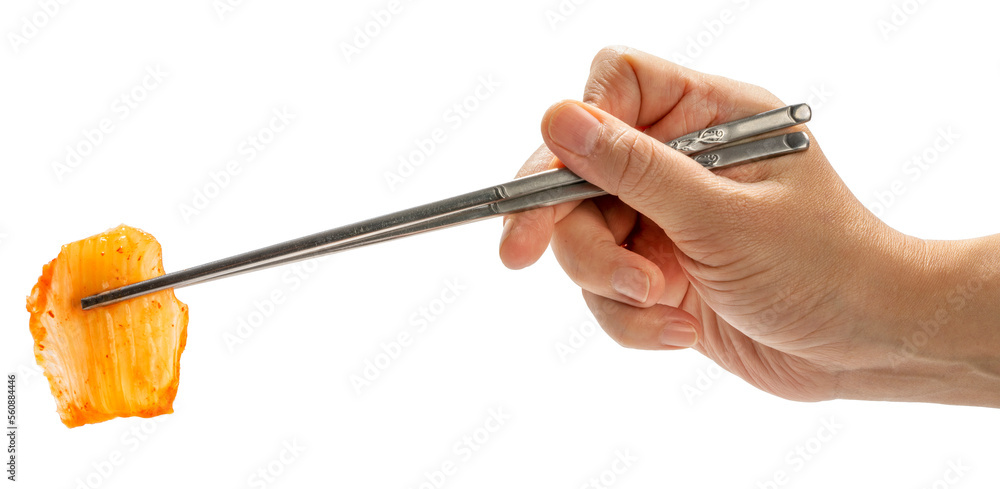 Hand using chopsticks to pick up Kimchi Korean pickle seasoning on ...