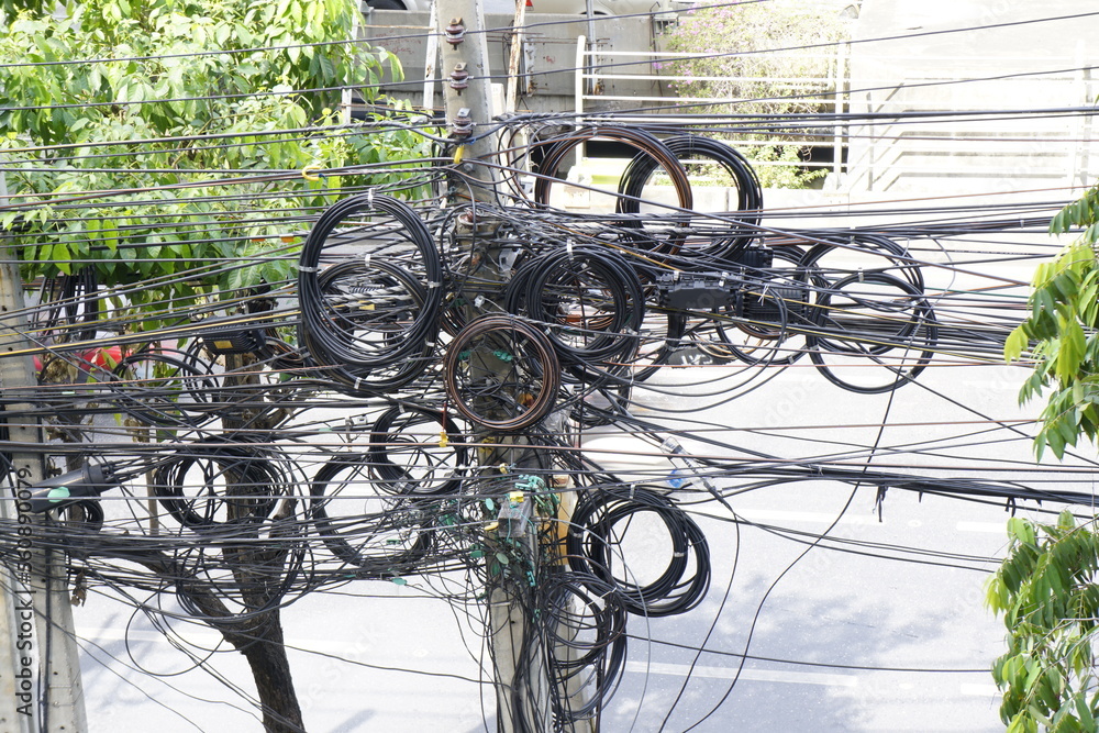 Messy electric cables on the concrete electric pole, not safety cables ...