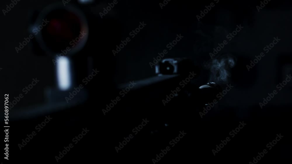 POV of AR-15 assault rifle firing in a dark room with smoke coming out ...