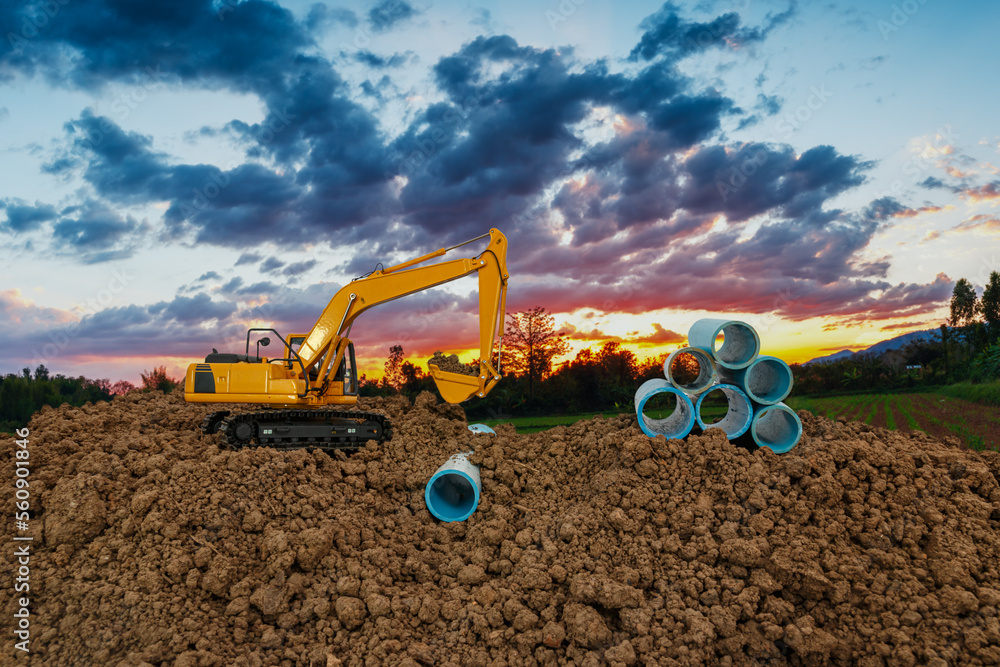 Crawler excavators digging water pipes at construction site and lift up ...