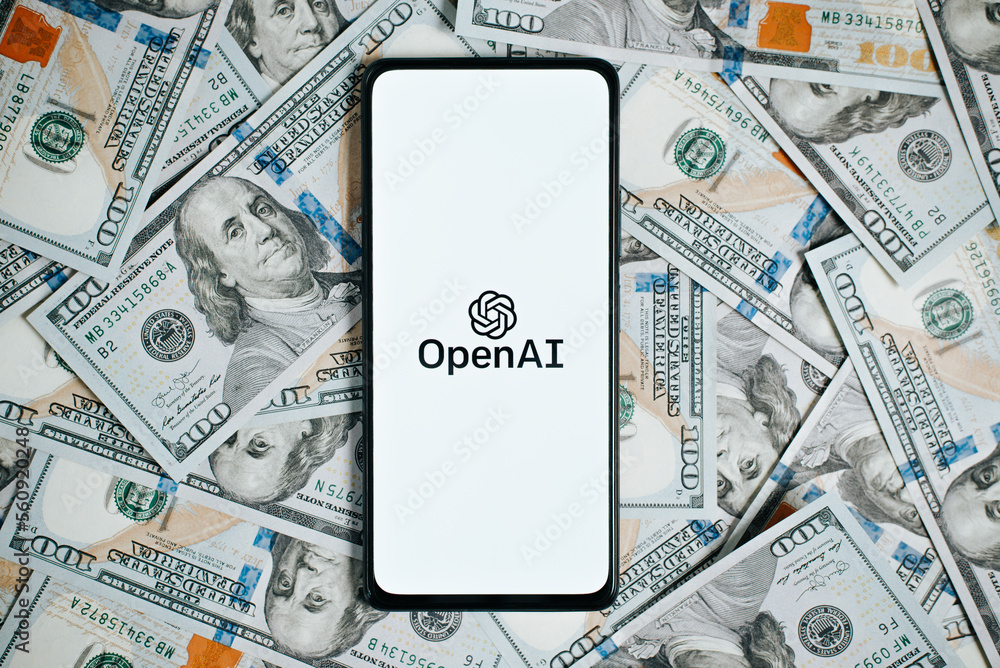OpenAi company logo on screen of smartphone lying on money background ...