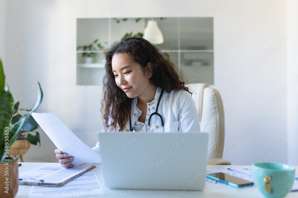 Doctor professional female Asian doctor wearing uniform taking notes in ...
