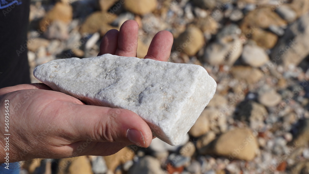 2000 years old piece of white marble in archeologist hand. Caesarea ...