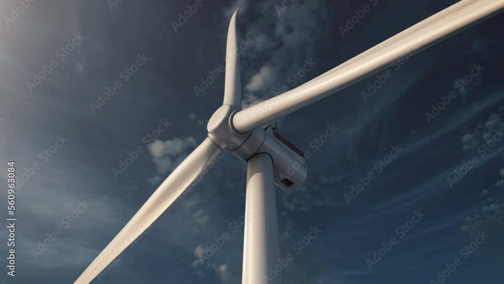 A white windmill with spinning wheels in daylight with a beautiful blue ...