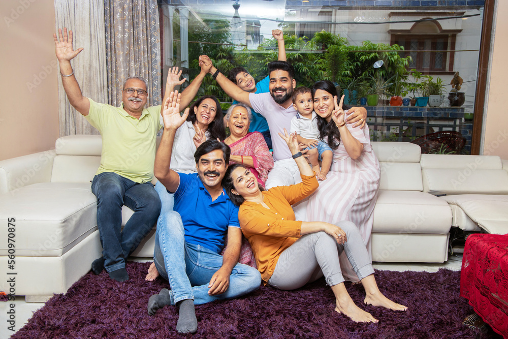Portrait of Happy cheerful indian joint family sitting together at home ...