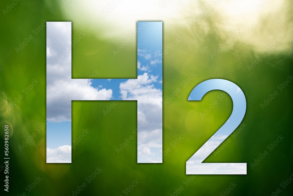 Mirror in the form of hydrogen formula H2 on green background. Sky ...