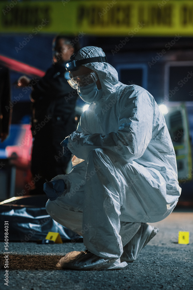 Fotka „Forensics Expert Observing Clues and Evidence on a Crime Scene ...