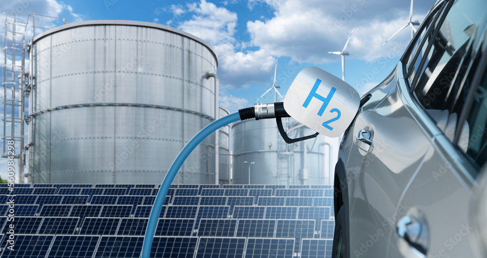 Car with hydrogen fueling nozzle on a background of H2 factory ...