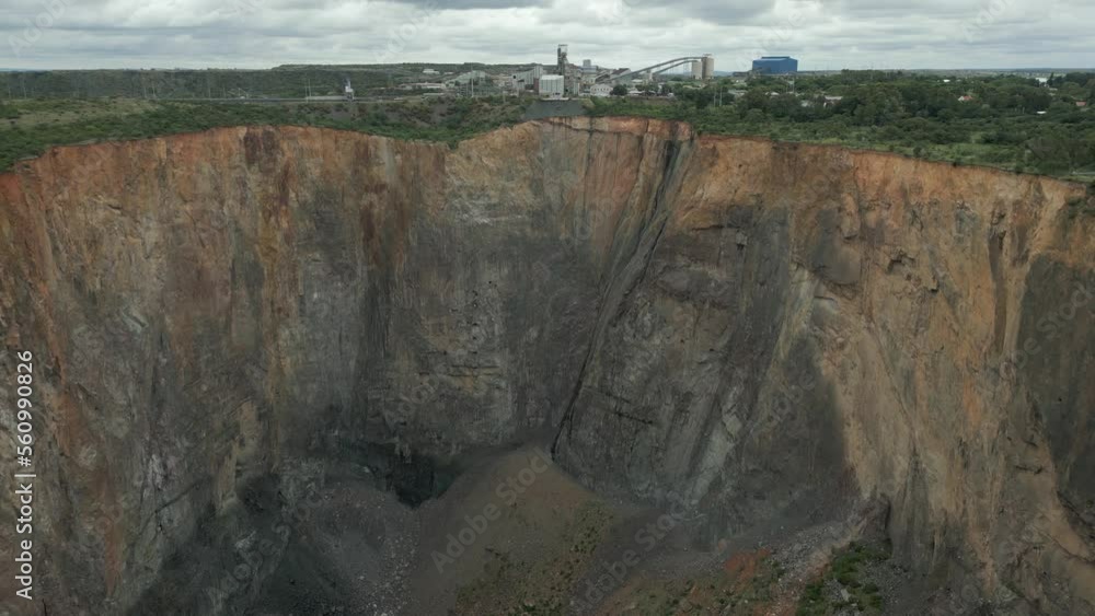 Dramatic aerial flyover of abandoned open pit of Cullinan Diamond Mine ...