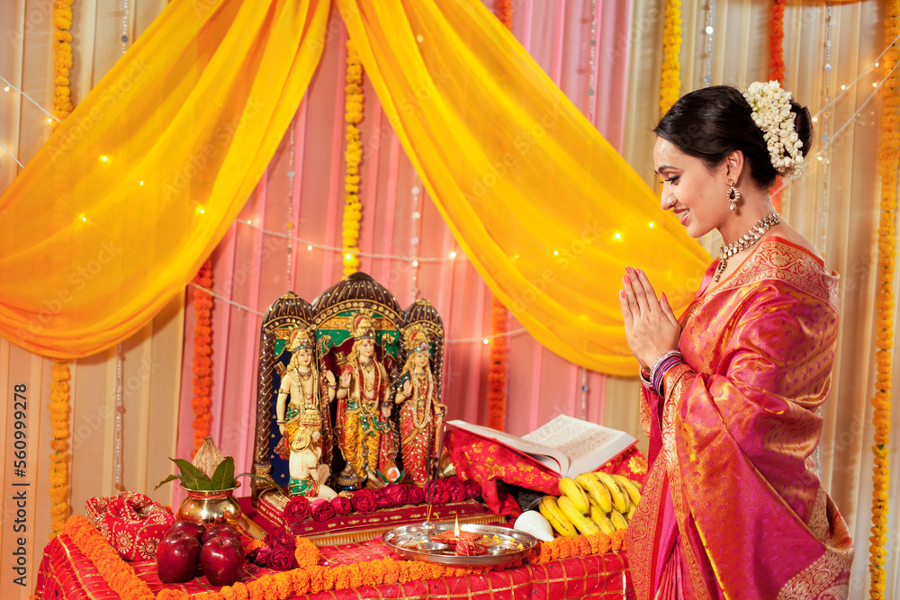 Women in prayer position holding hands in front of Lord Rama - Taking ...