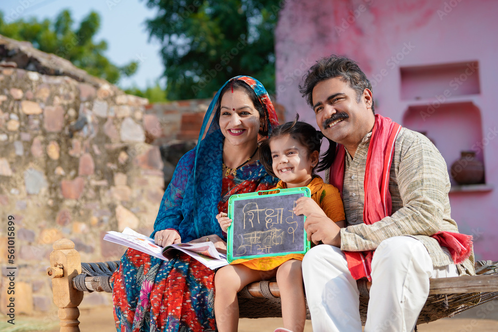 education concept : Indian rural couple showing shiksha words in hindi ...