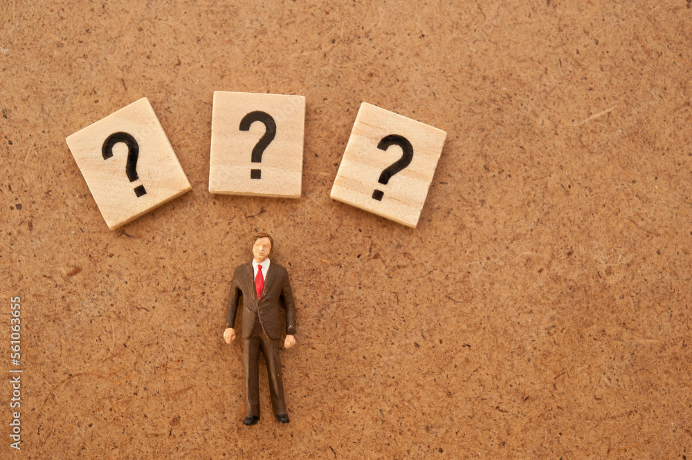 miniature figurine with question marks around him Stock Photo | Adobe Stock