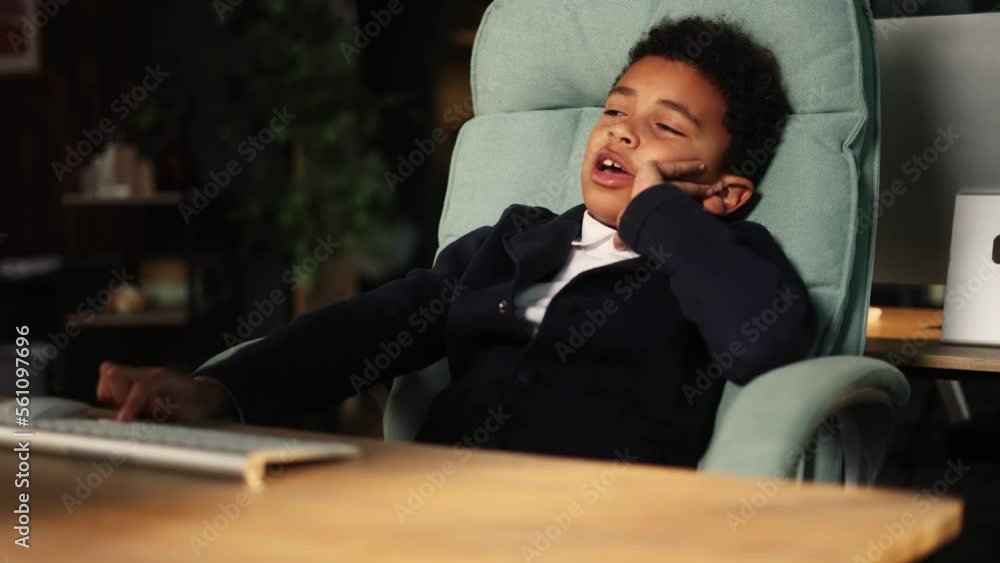 Boring little businessman kid having long work day with lack of ...