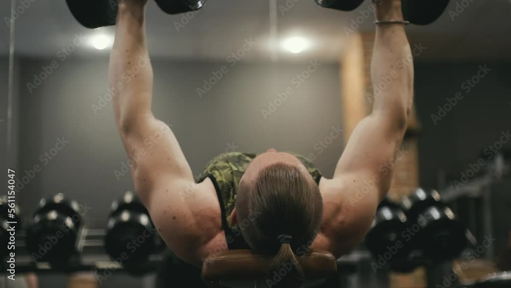 Muscular bodybuilder man lifting heavy weights black dumbbells. Gym ...
