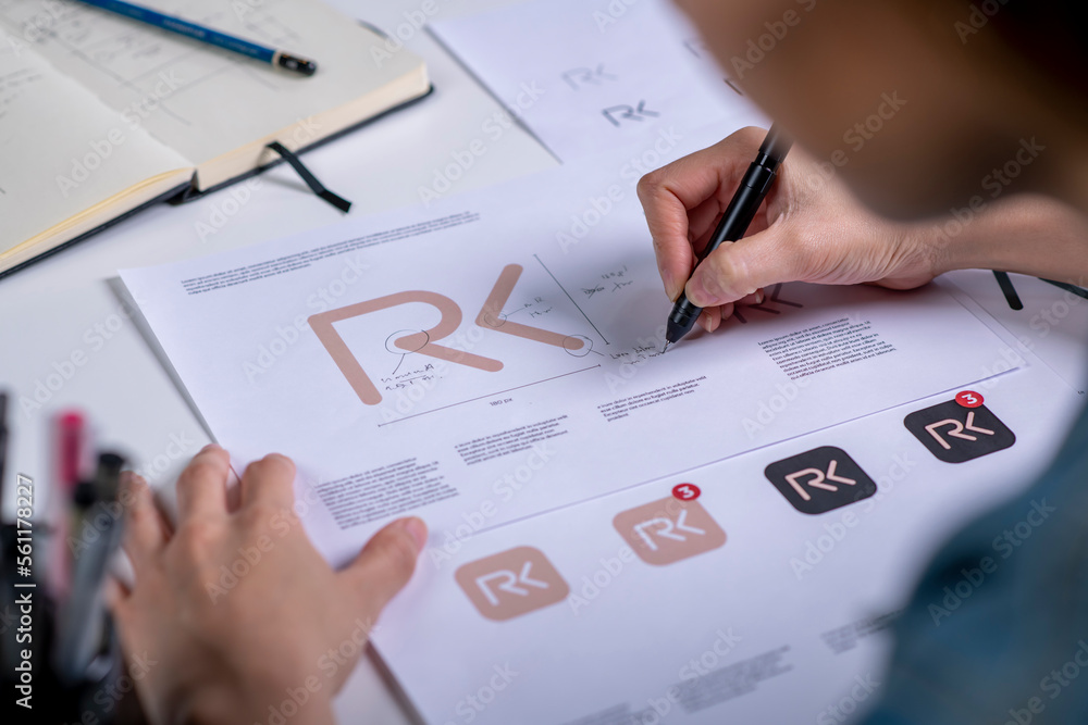 Graphic designer drawing sketches logo design. The concept of a new ...