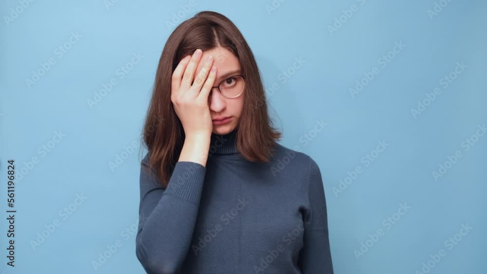 Video portrait of a frustrated student girl in glasses and a sweater ...