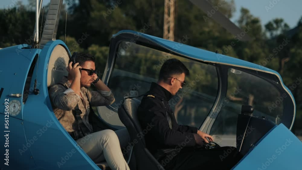 Captain and passenger preparing for flight. The captain and passenger ...