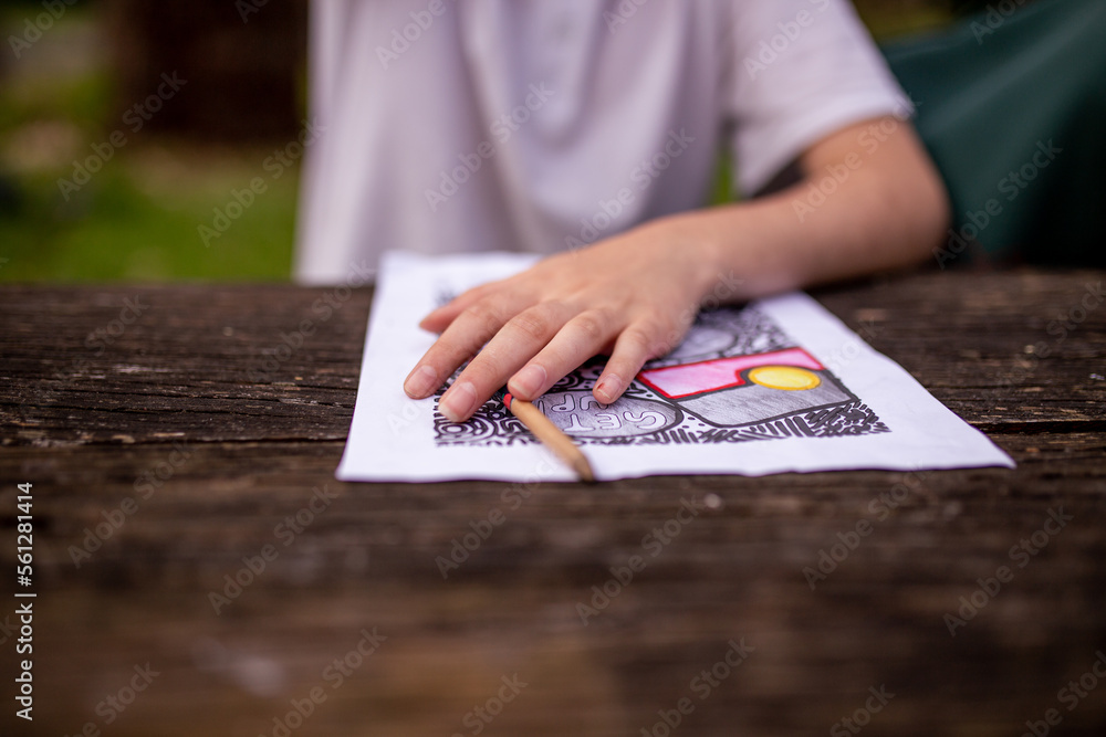 A young Aboriginal girl's hand resting on a drawing of the Aboriginal ...