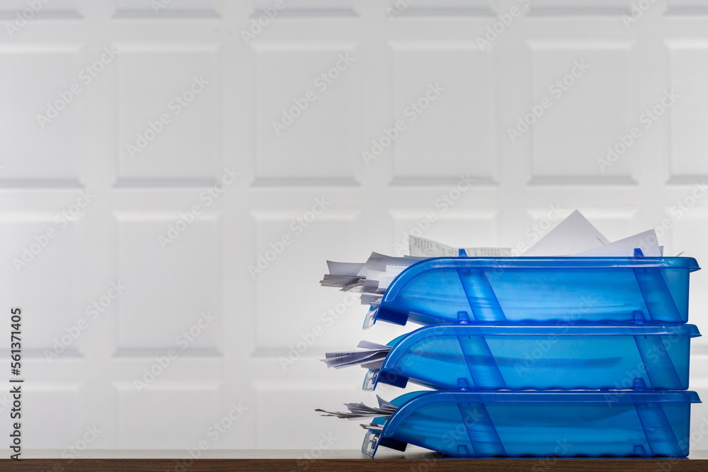 Overflowing with paperwork, accounts or receipts, three stacked, modern ...