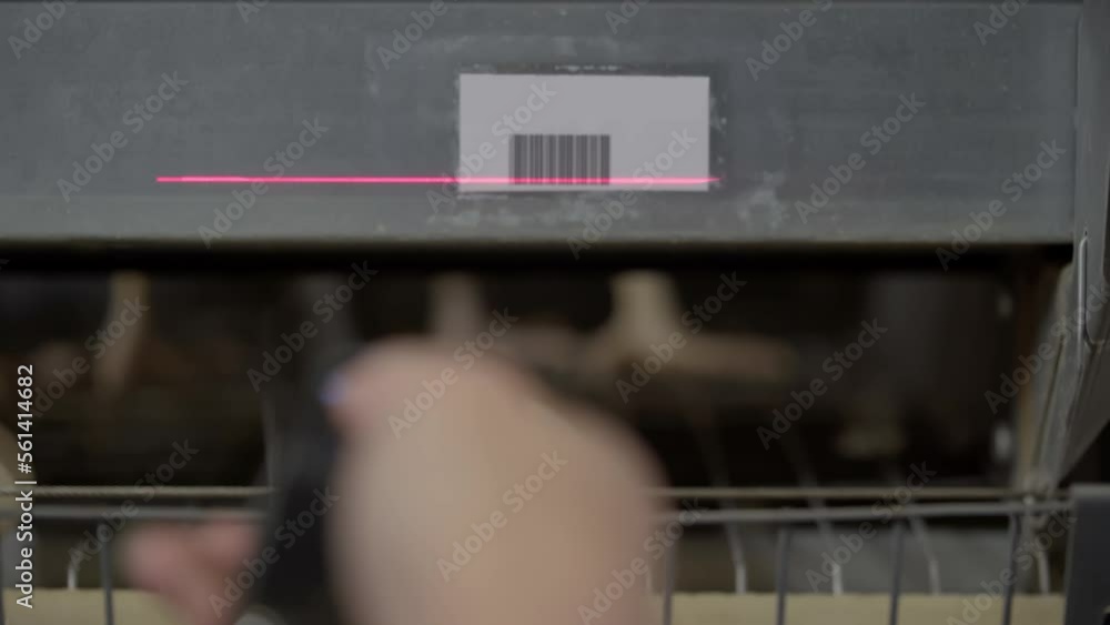 Vidéo Stock Pointing the laser scanner on the product barcode above the ...