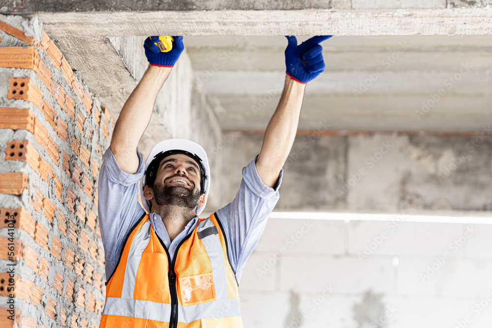 Engineering male builders use tape measures to measure and calculate ...