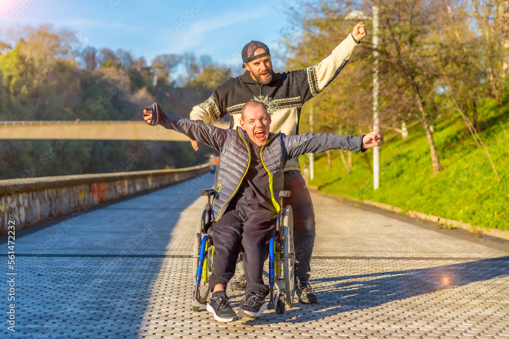 Disabled person in wheelchair with friend overjoyed, smiling, enjoying ...