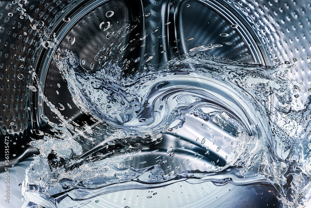 Washing machine drum with clean water flow and splashes. Laundry ...