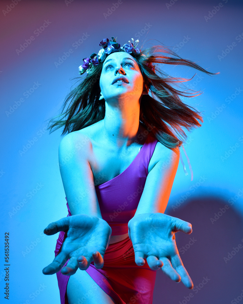 Low angle portrait of pretty girl wearing pink outfit, gestural arm ...