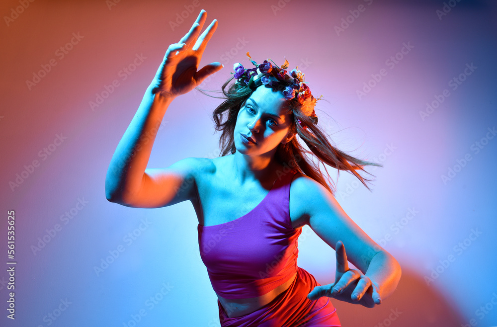 Low angle portrait of pretty girl wearing pink outfit, gestural arm ...