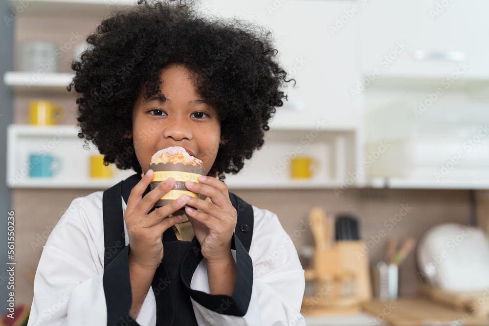 Happy African American child girl wearing chef uniform holding and ...