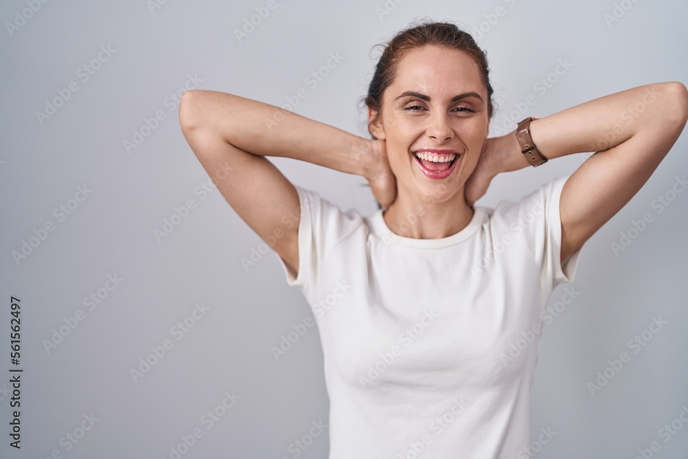 Beautiful brunette woman standing over isolated background relaxing and ...